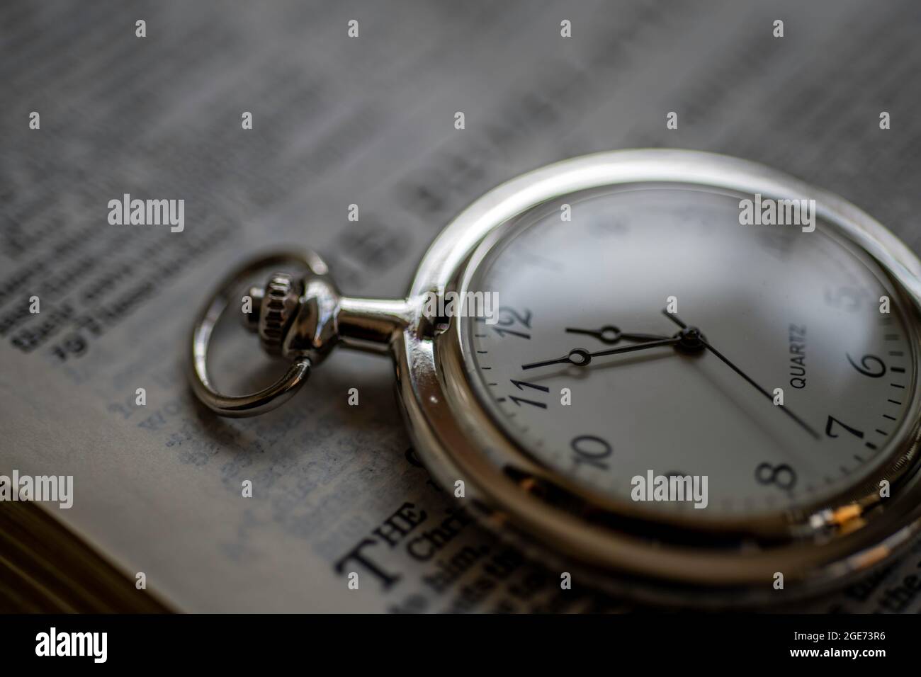Open bible and a pocket watch Stock Photo - Alamy