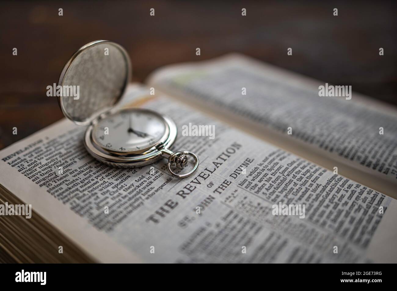 Open bible and a pocket watch Stock Photo - Alamy