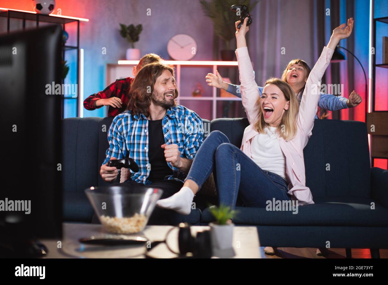 Mother and daughter celebrating win during competition in video games ...