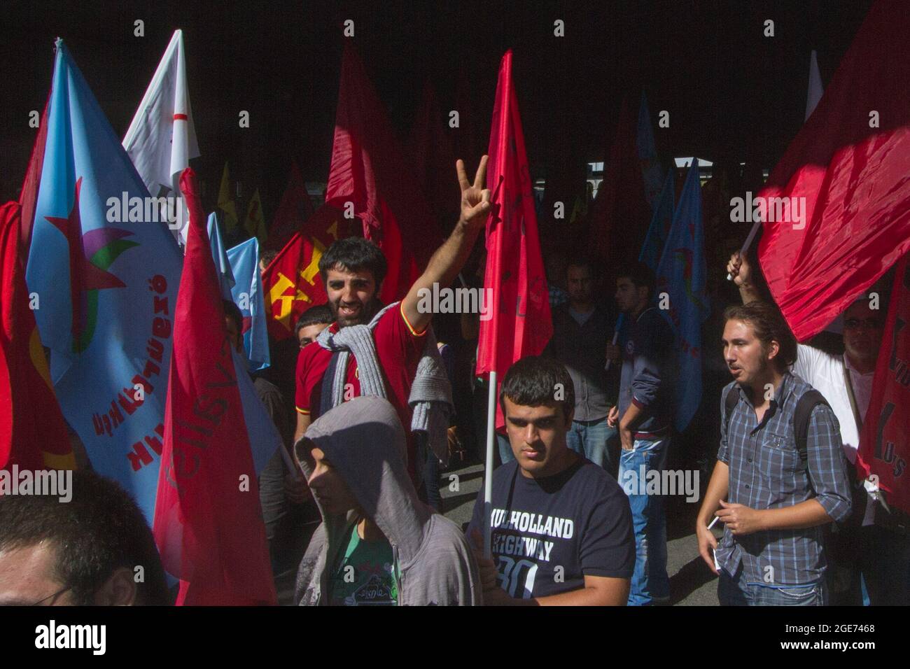 A man with flags of Turkish Communist Party makes the V sign during the ...