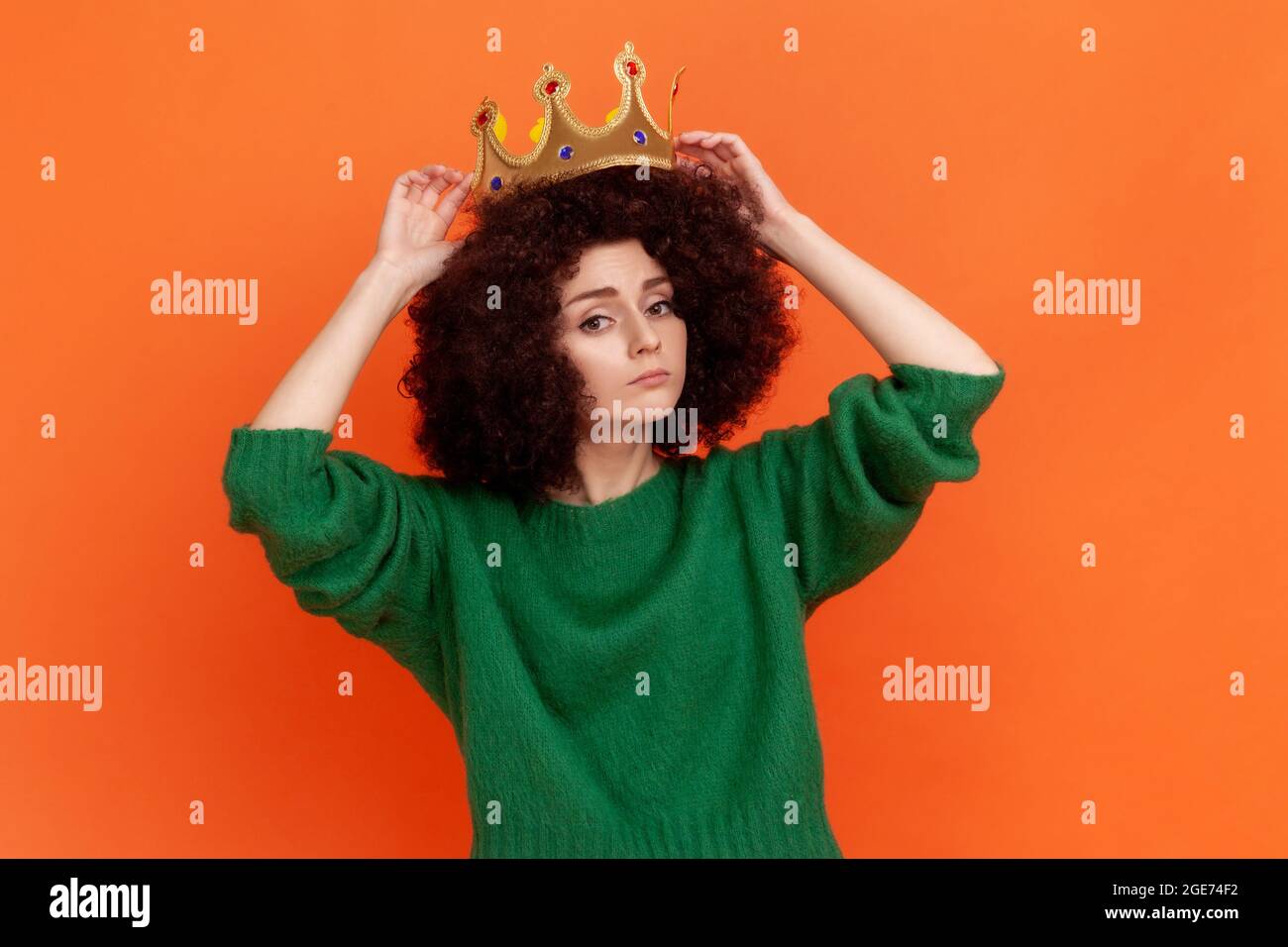 Selfish woman with curly hair wearing green casual style sweater and ...