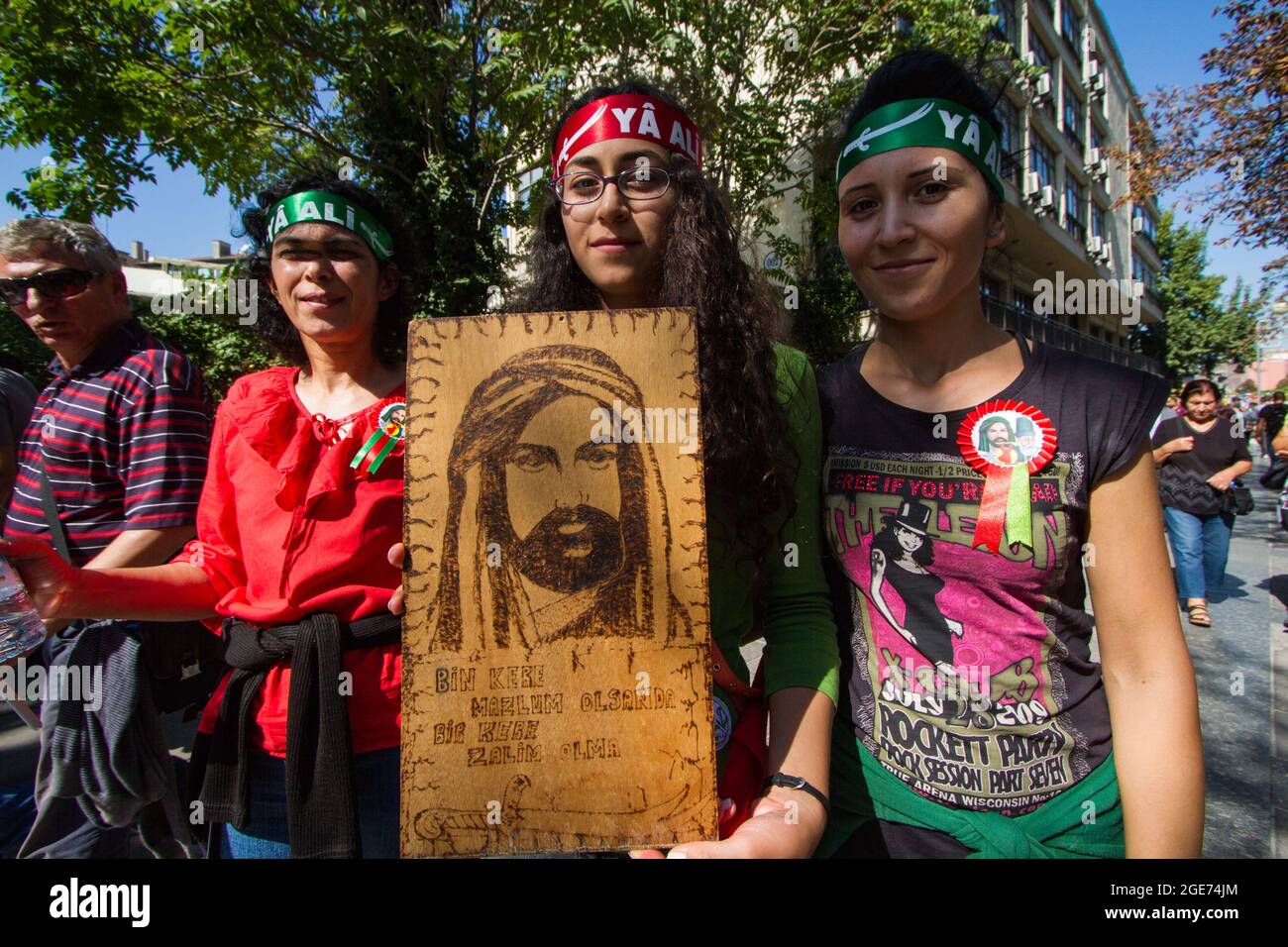 Girls carry a portrait of Imam Ali during the Alevis' demonstration ...