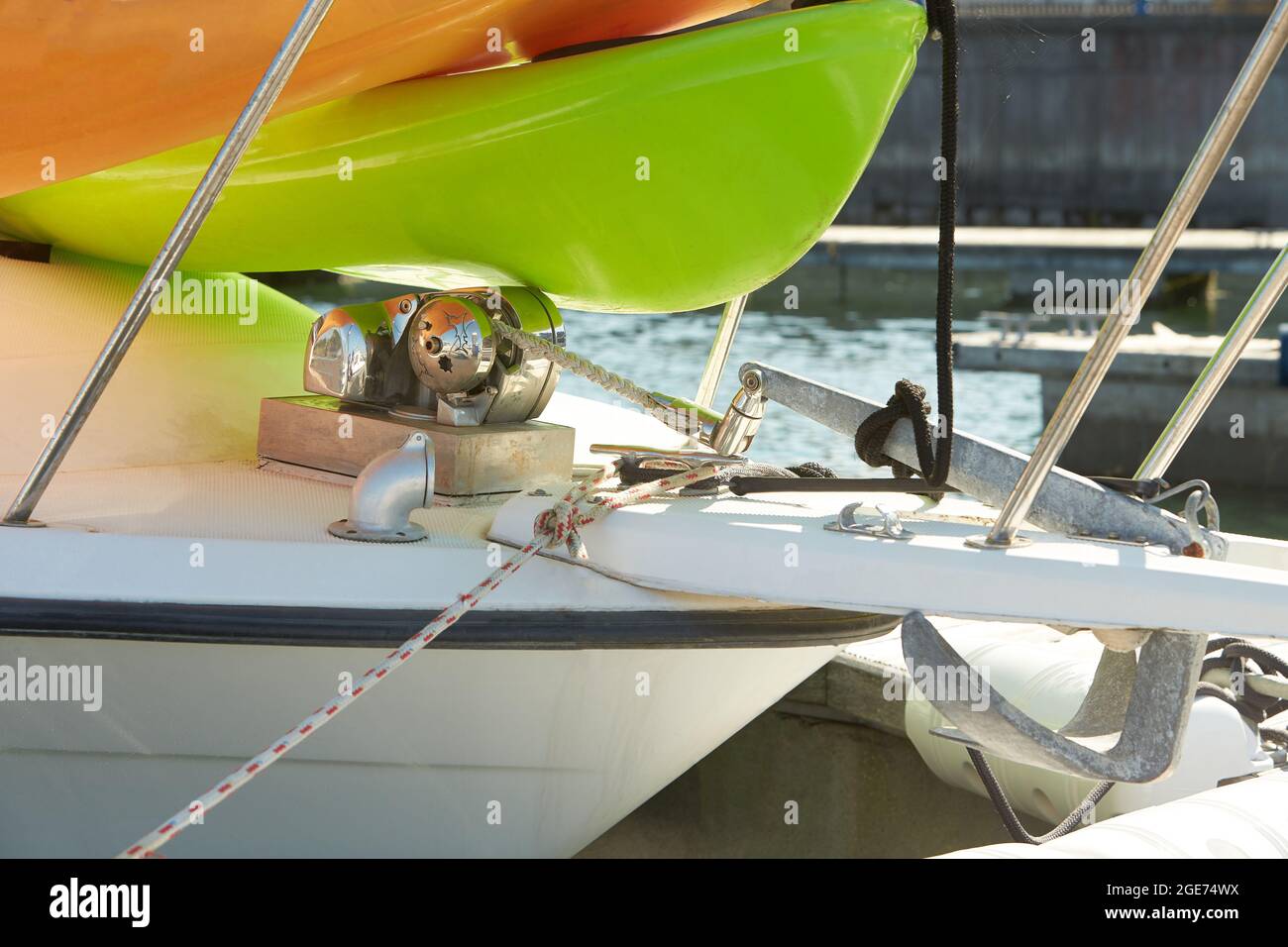 The bow of the yacht with anchor stops, a winch, a bollard with a ...
