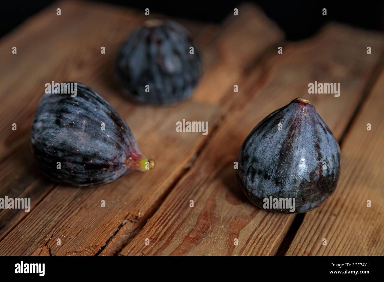 Fresh purple figs on a wooden background from old boards. Raw exotic ...