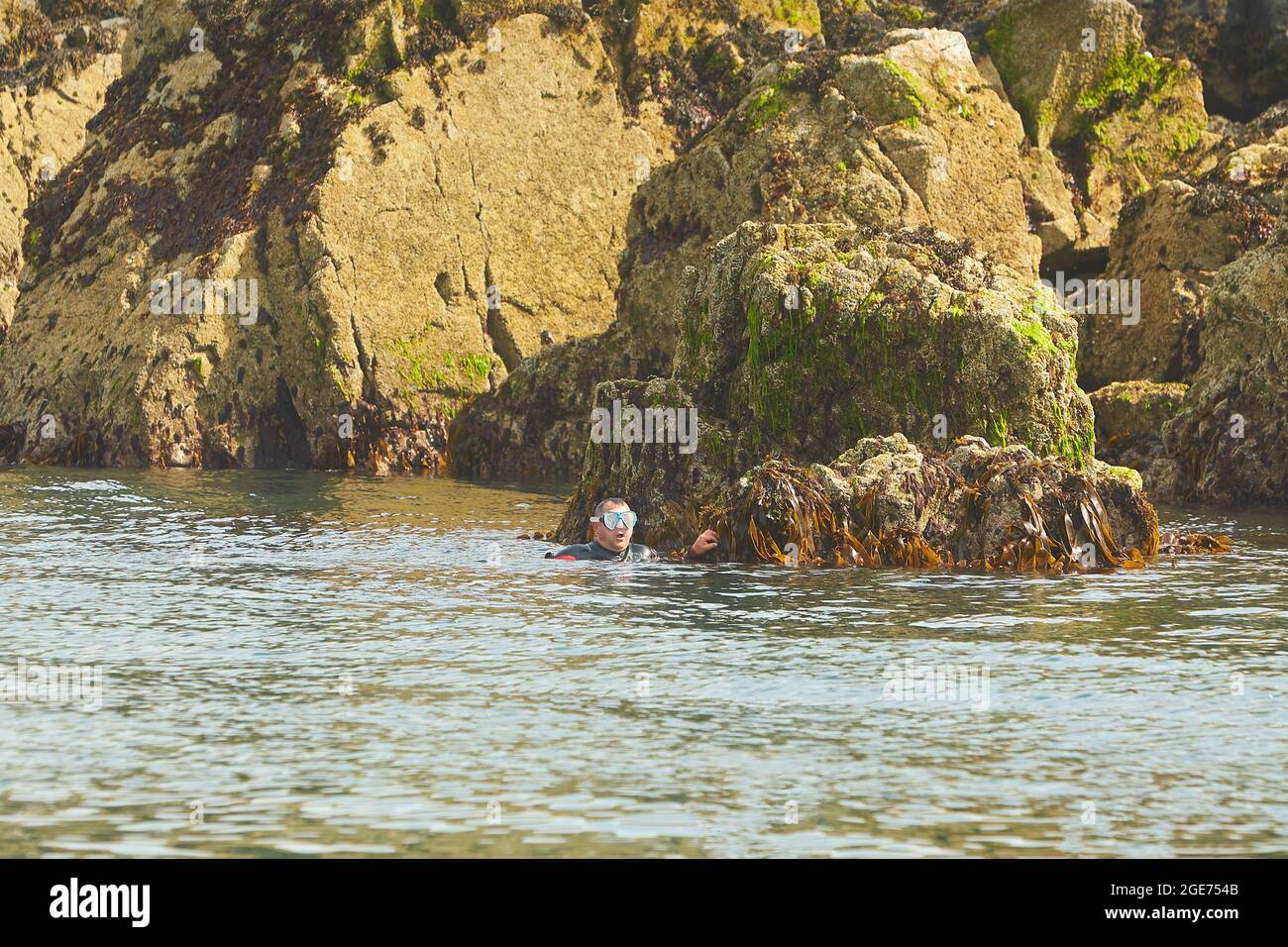 Man diver without a hand set out to dive near island Stock Photo - Alamy