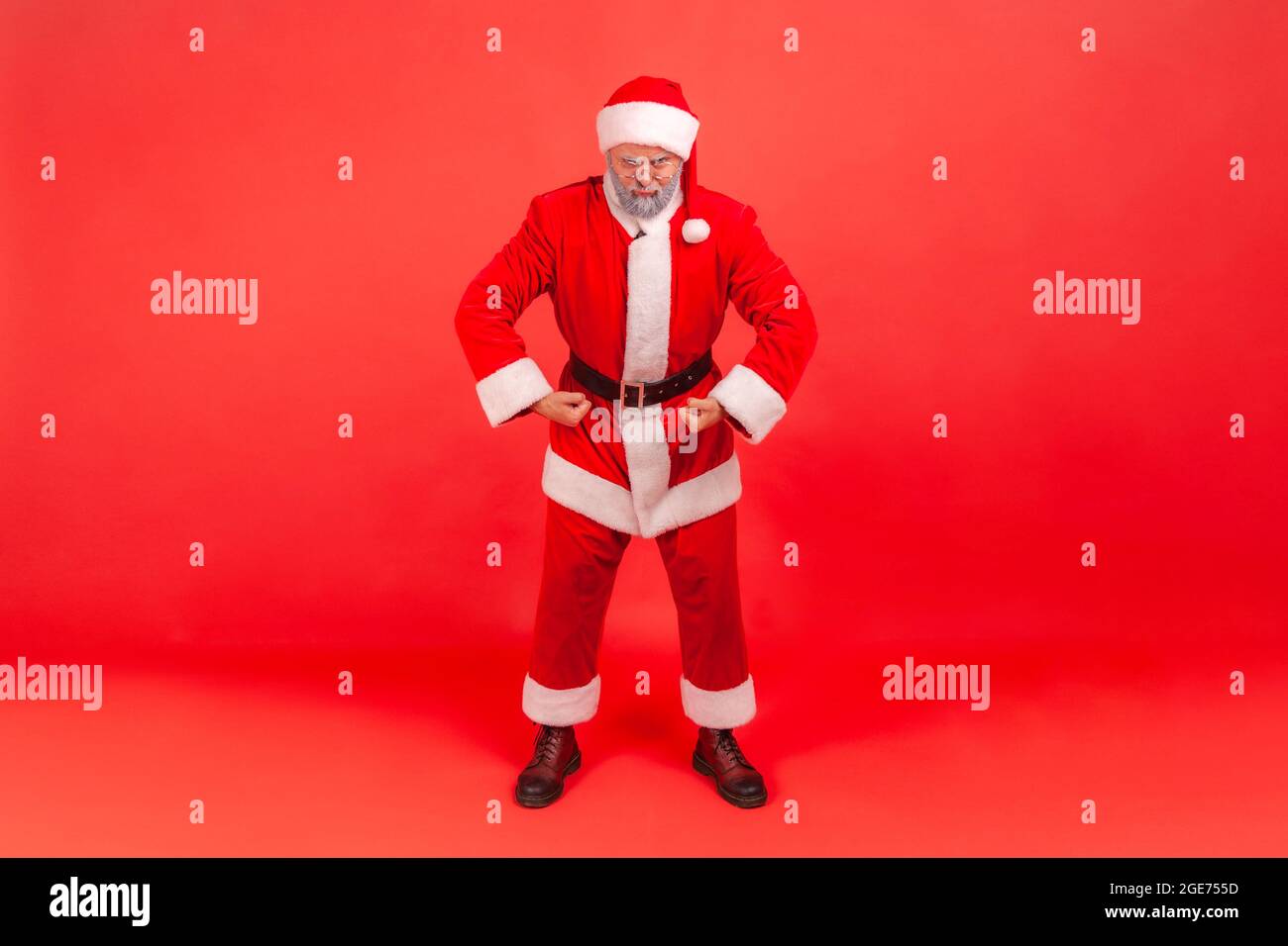 I am strong. Portrait of funny elderly man with gray beard wearing ...