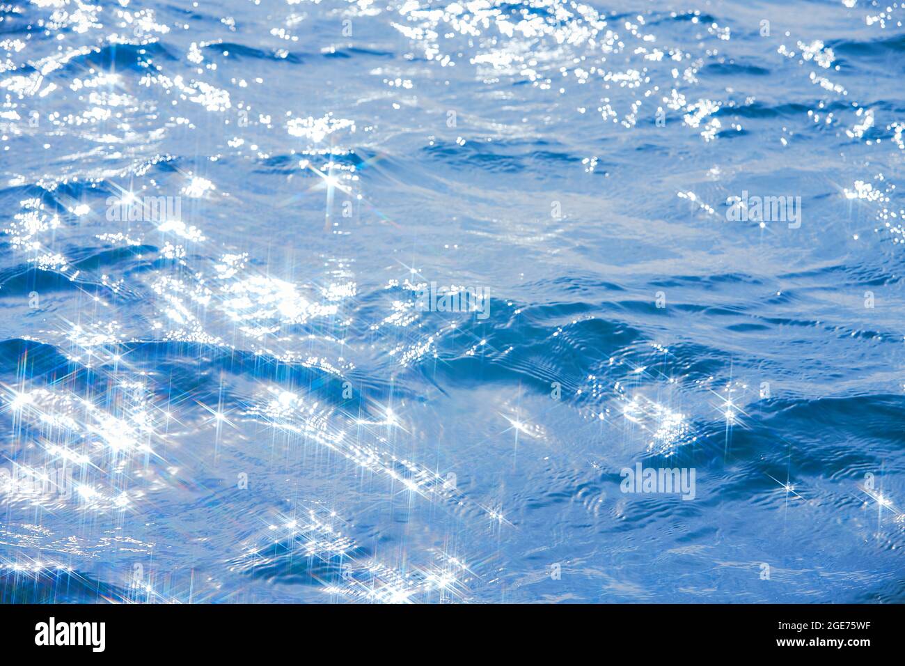 Detail of a sunlight reflecting in glittering sea. sparkler in water ...