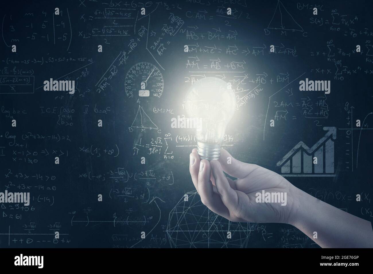 Idea concept - light bulb illuminating a blackboard with math formulas ...