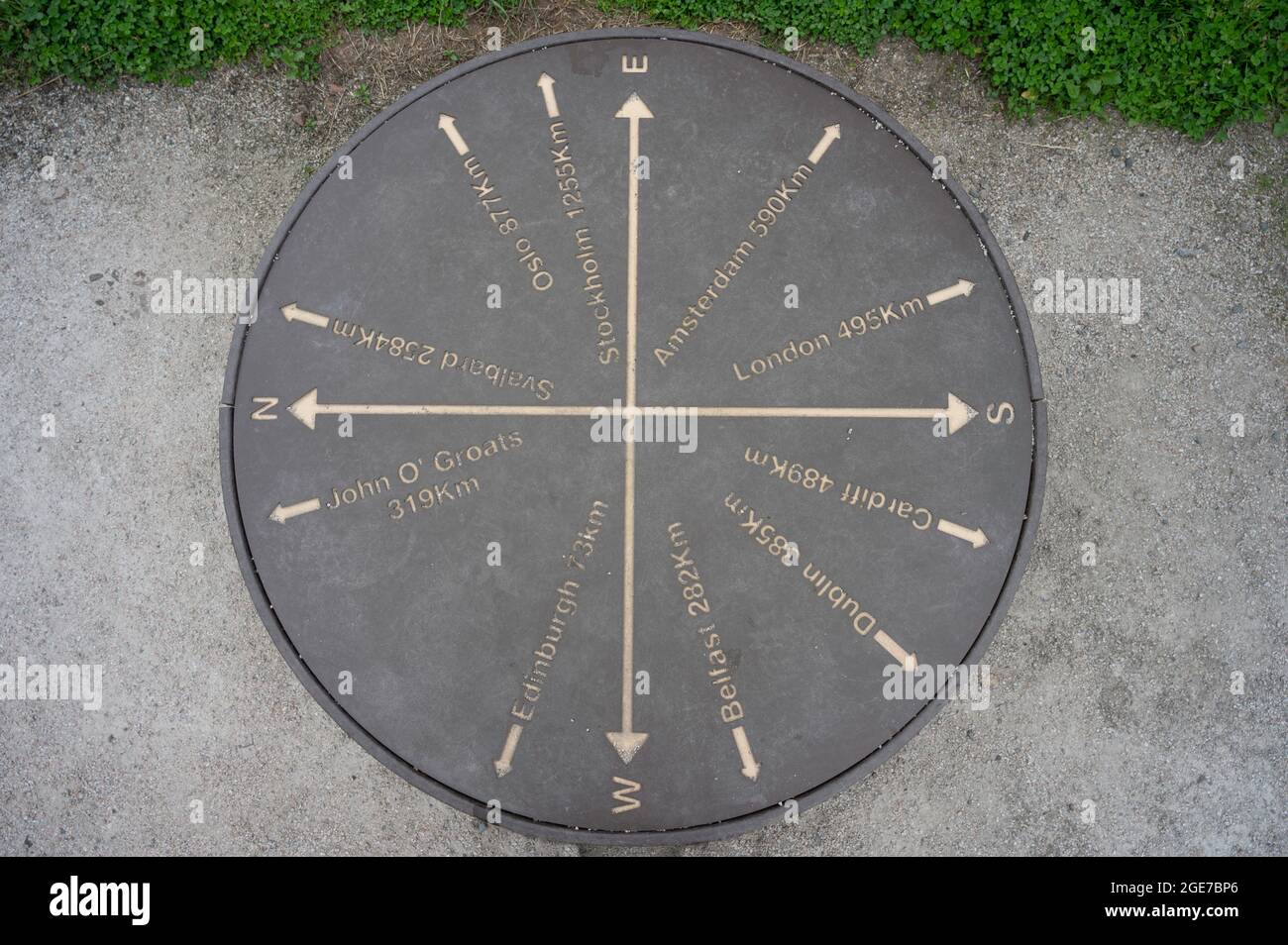 Ground plaque with north, south, east and west, and various place names ...