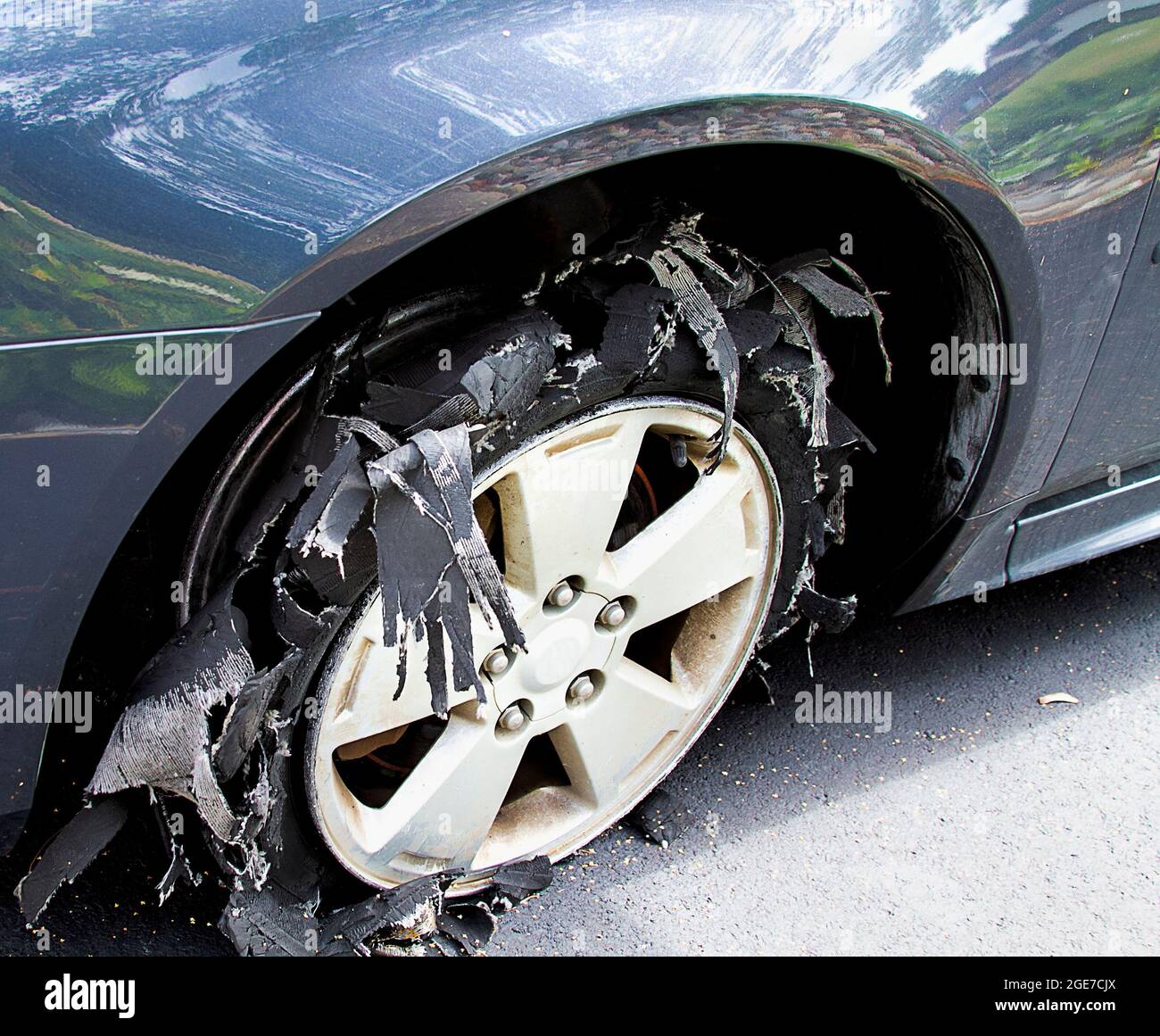 Severely blown-out tire with rubber shredded to pieces Stock Photo - Alamy