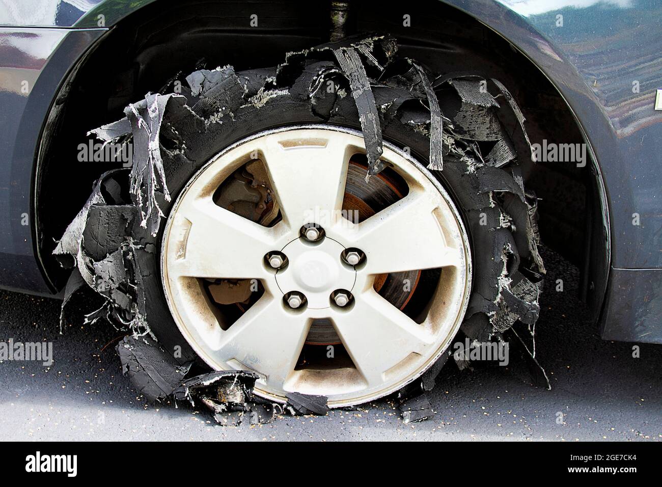 Severely blown-out tire with rubber shredded to pieces Stock Photo - Alamy