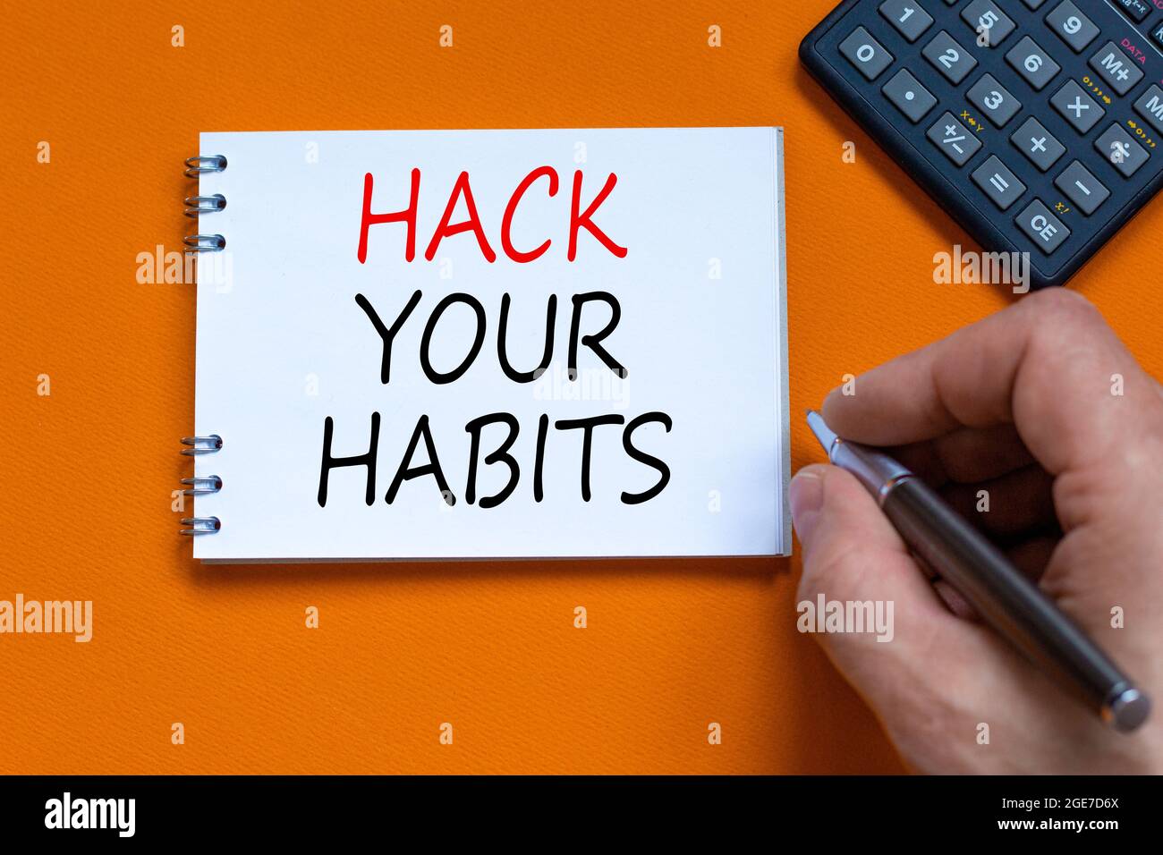 Hack your habits symbol. Businessman writing words 'Hack your habits' on white note. Black ...