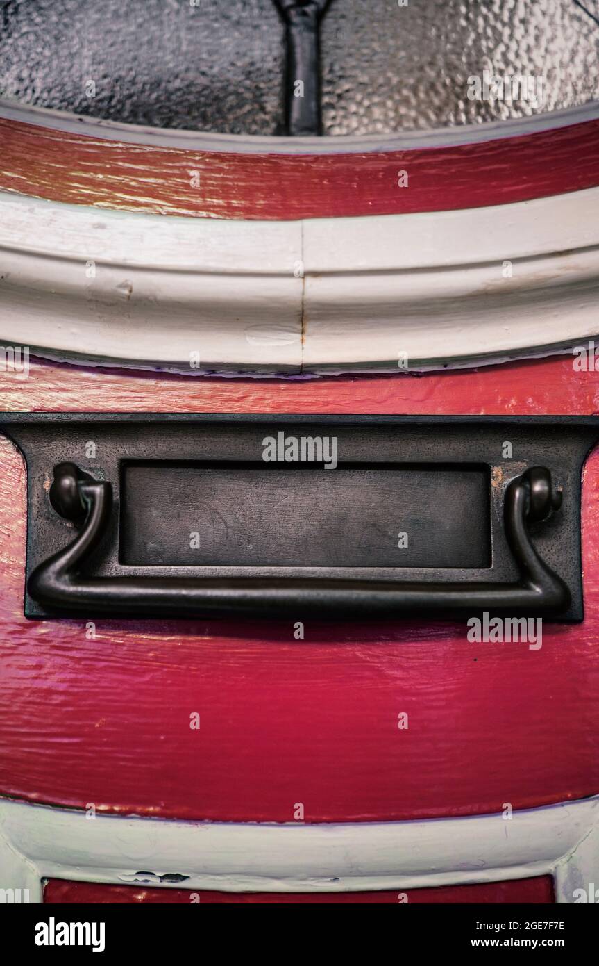 Detail of a letterbox in the red front door of a house Stock Photo - Alamy