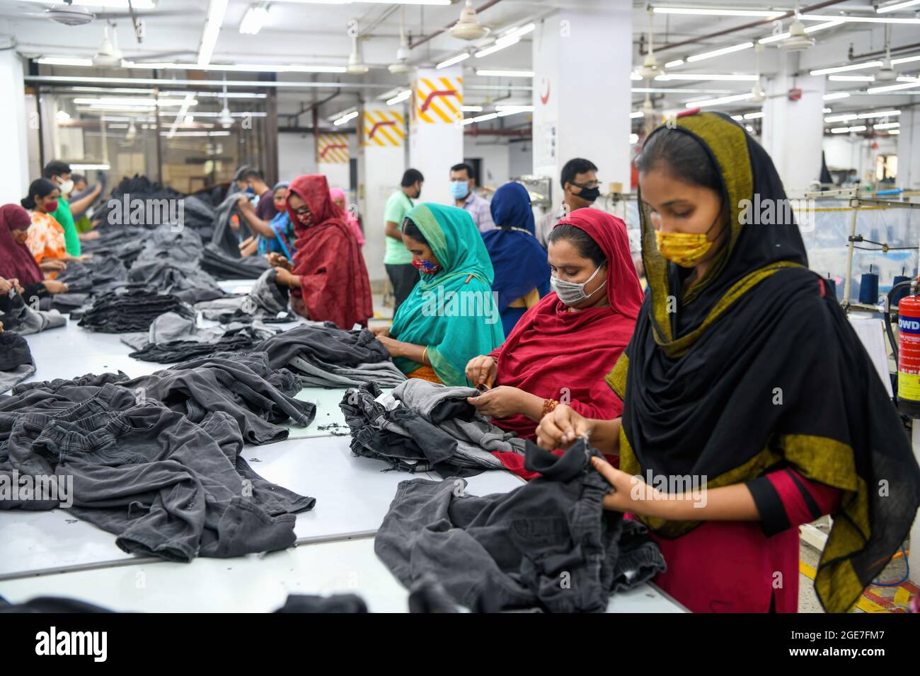 Ready-Made Garment (RMG) workers wearing face masks during their work ...