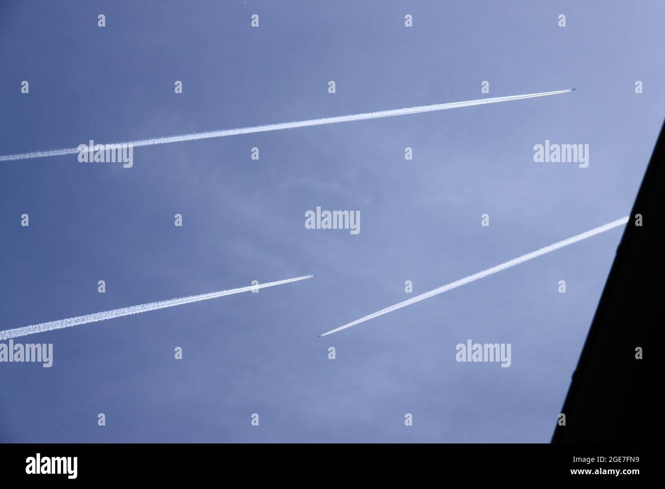 Contrails in blue sky Stock Photo - Alamy