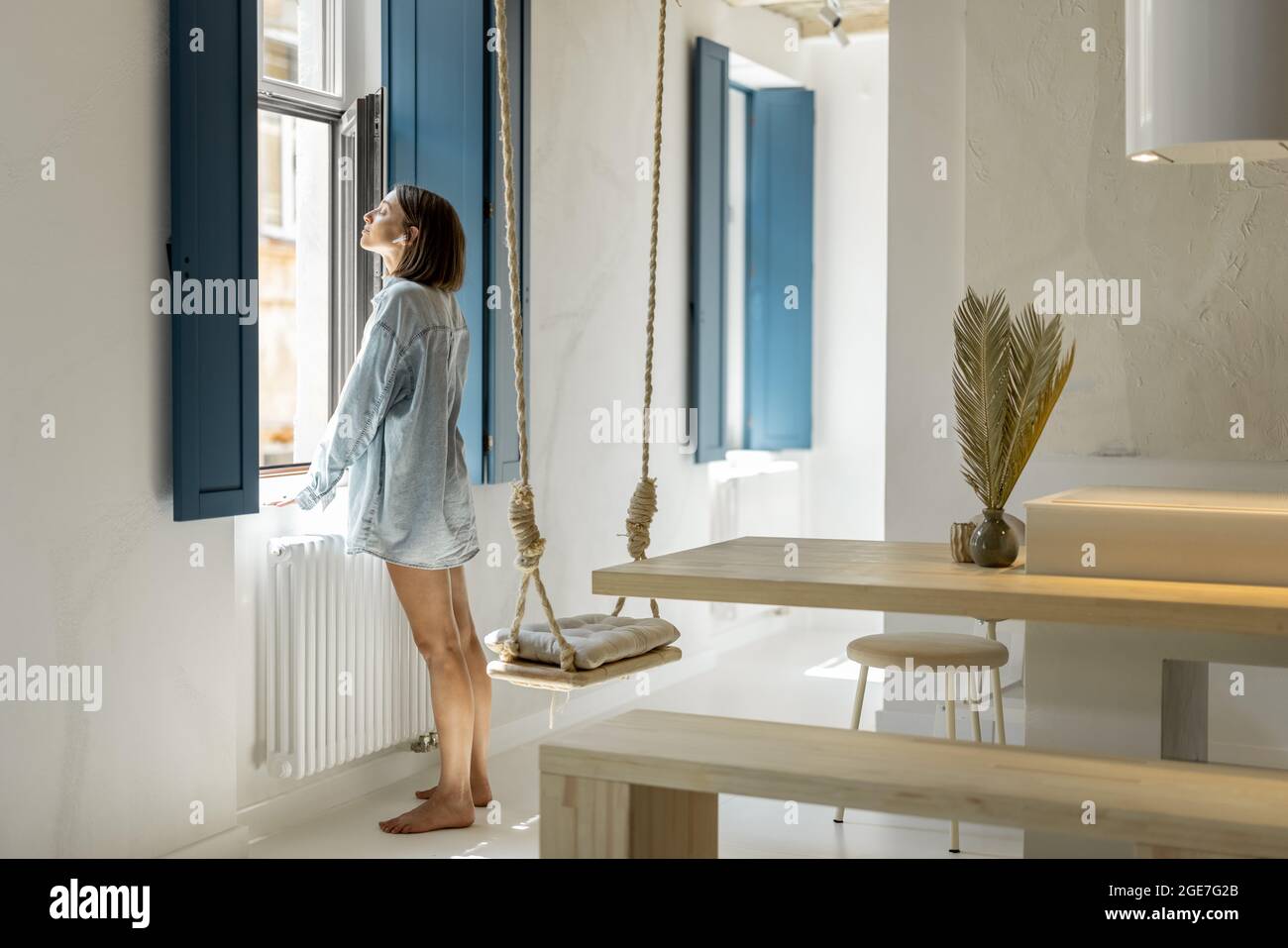 Woman near the window in a bright and modern home Stock Photo - Alamy