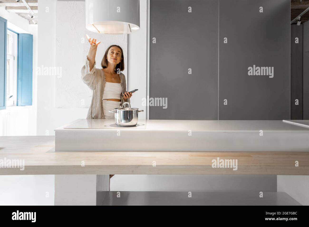 Woman cooking at modern kitchen Stock Photo - Alamy