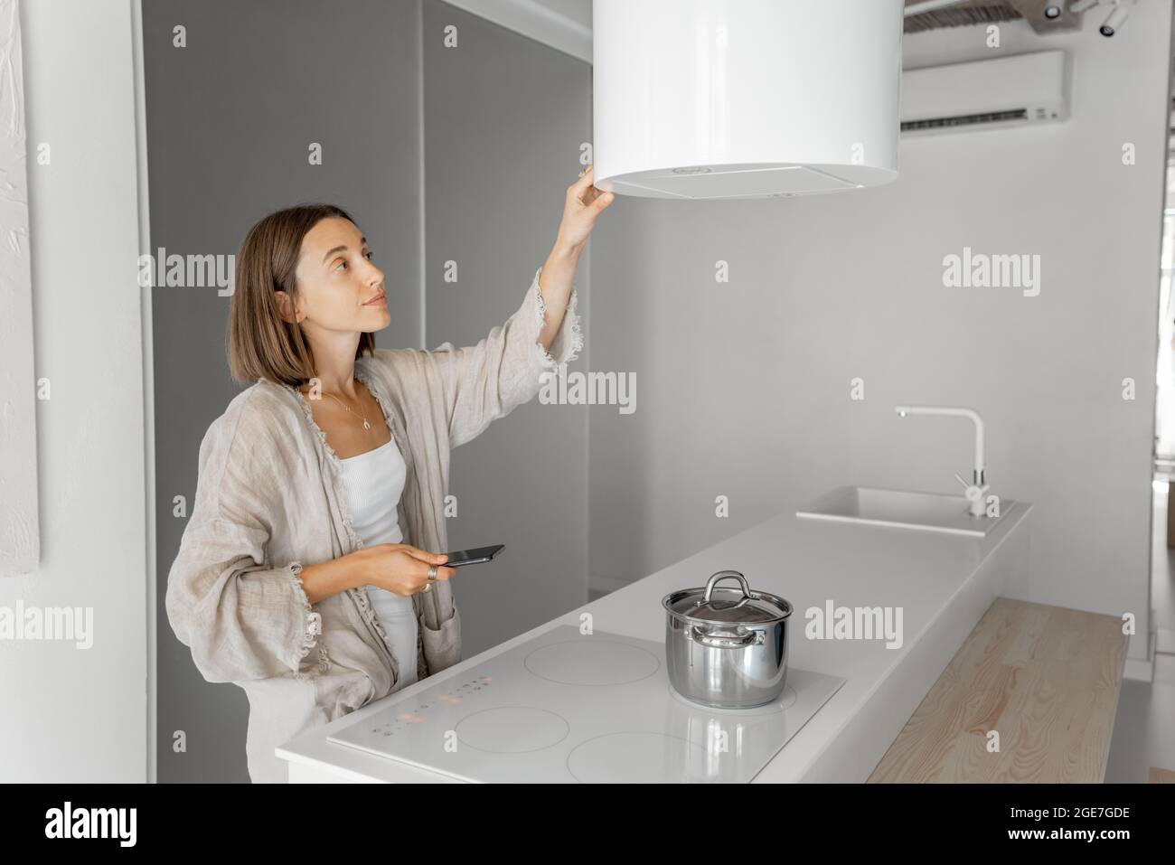 Woman cooking at modern kitchen Stock Photo - Alamy