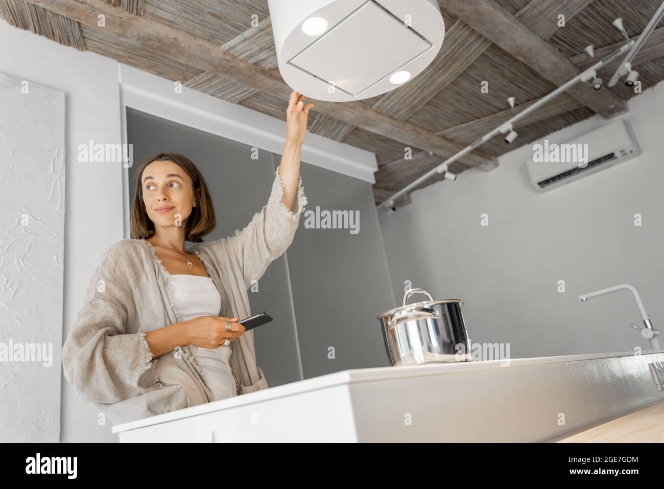 Woman cooking at modern kitchen Stock Photo - Alamy