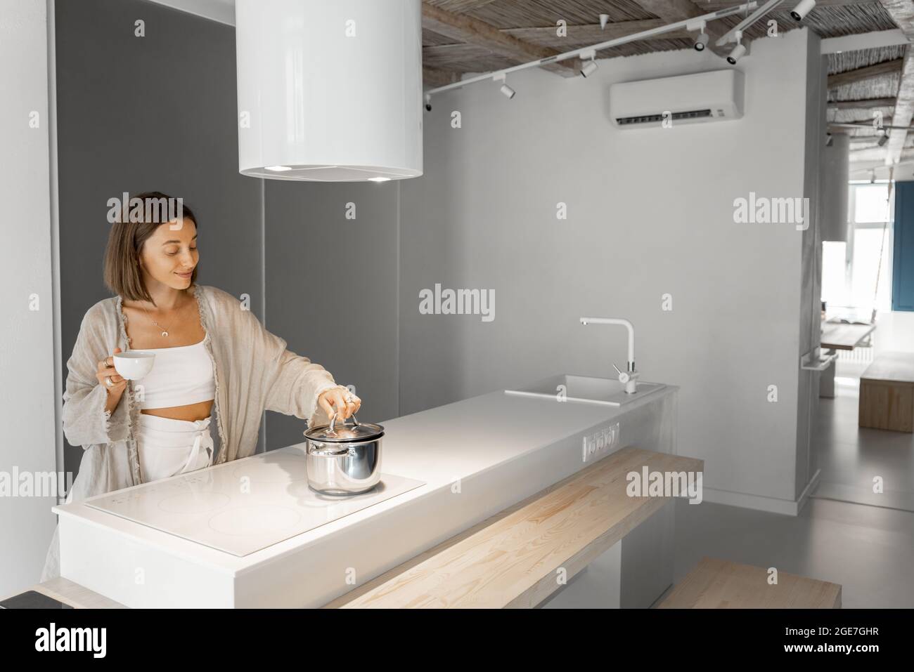 Woman cooking at modern kitchen Stock Photo - Alamy