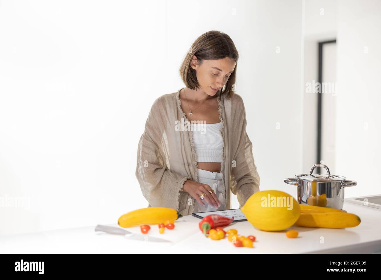 Woman cooking healthy food at modern kitchen Stock Photo - Alamy
