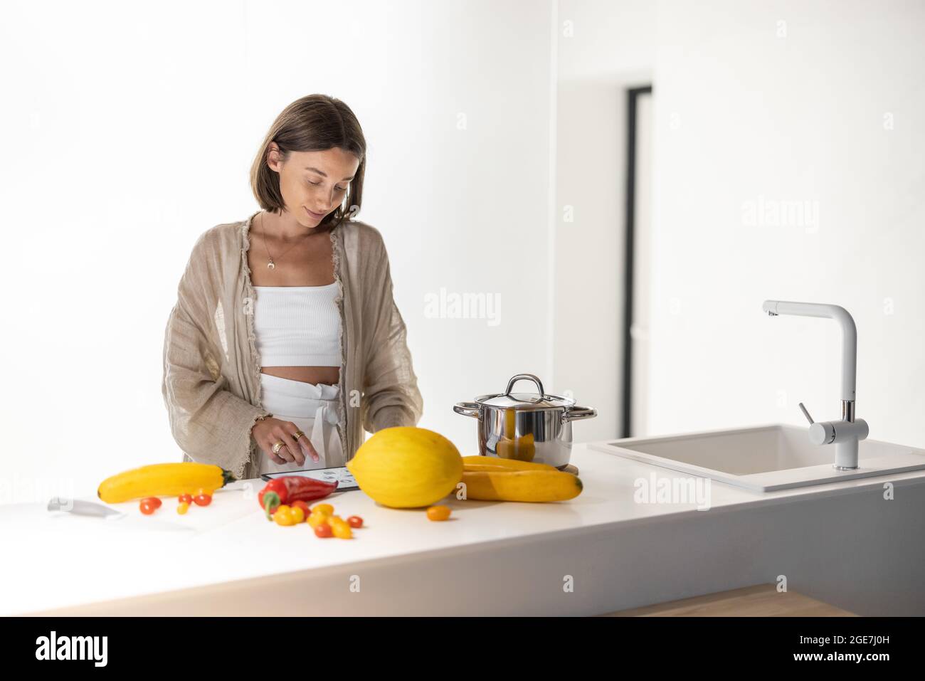 Woman cooking healthy food at modern kitchen Stock Photo - Alamy