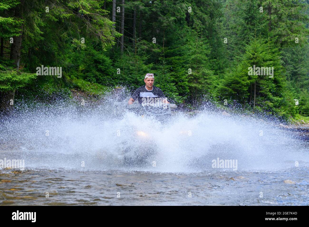 Close ATV racing on mountain river track at summer mountain Stock Photo ...