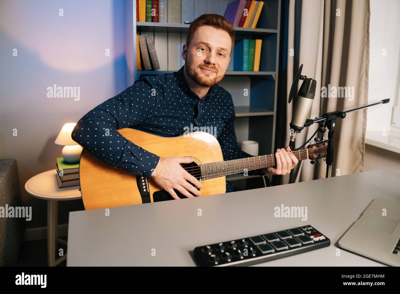 Medium shot of handsome guitarist singer man play on acoustic guitar ...