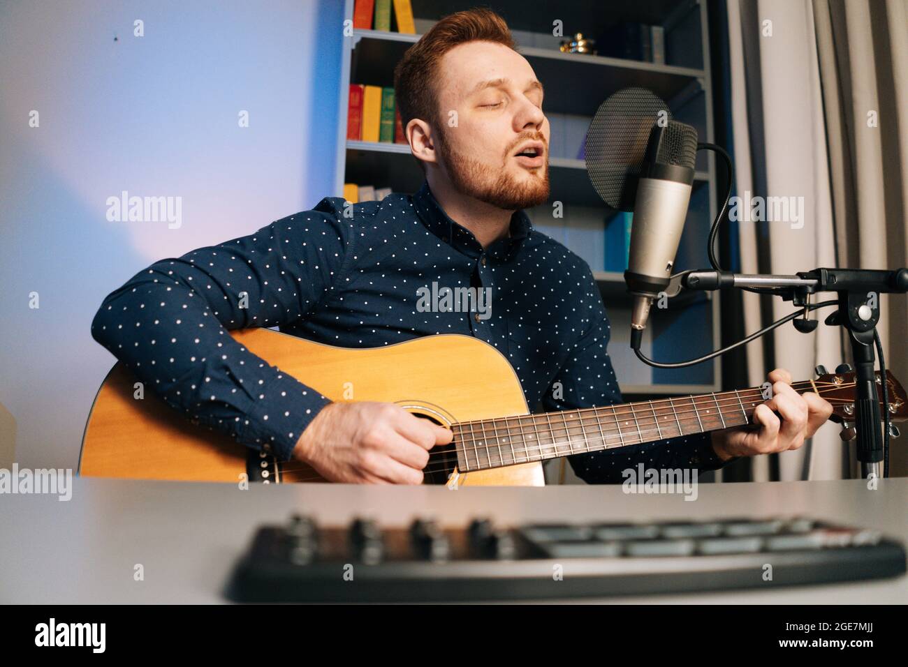 Close-up shoot from below of guitarist singer man play on acoustic ...