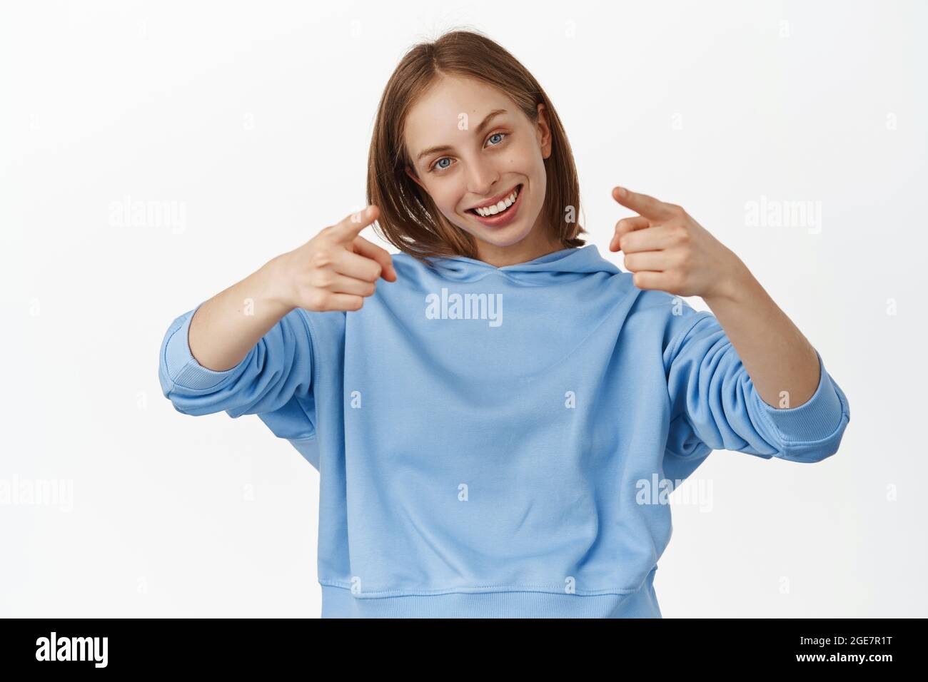 She chooses you. Smiling blond girl pointing fingers at camera with ...