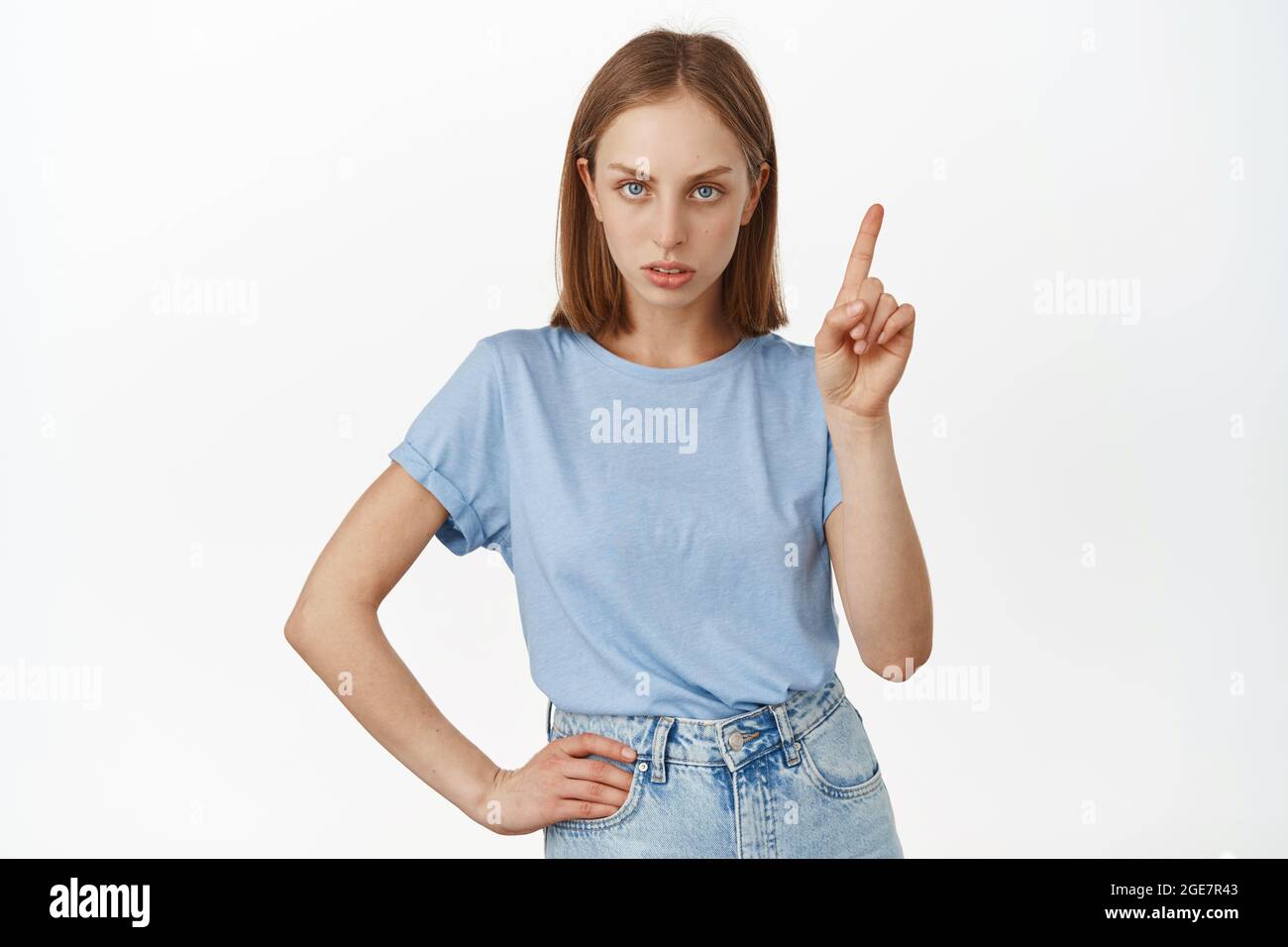 No its forbidden. Serious blond girl shaking finger in disapproval ...