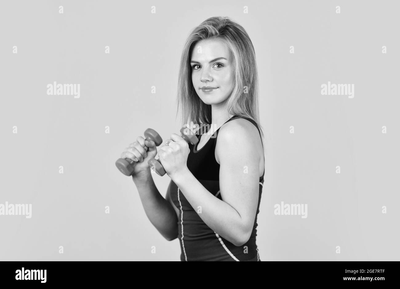 muscular woman in training pumping up muscles of hands. girl use ...