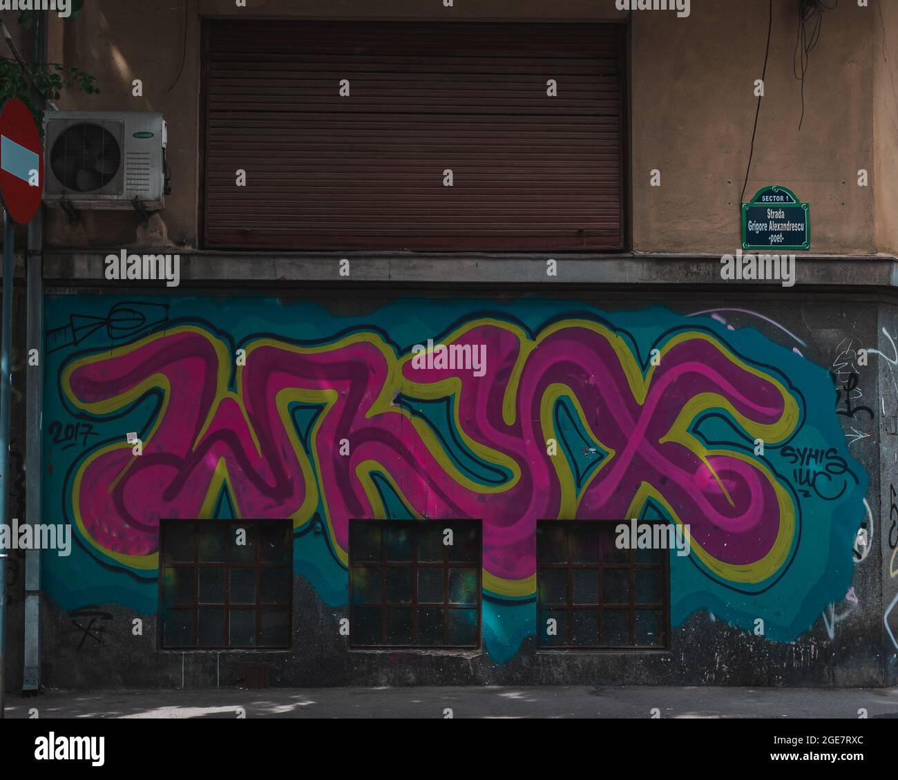 BUCHAREST, ROMANIA - May 01, 2021: A blue and pink graffiti on the ...