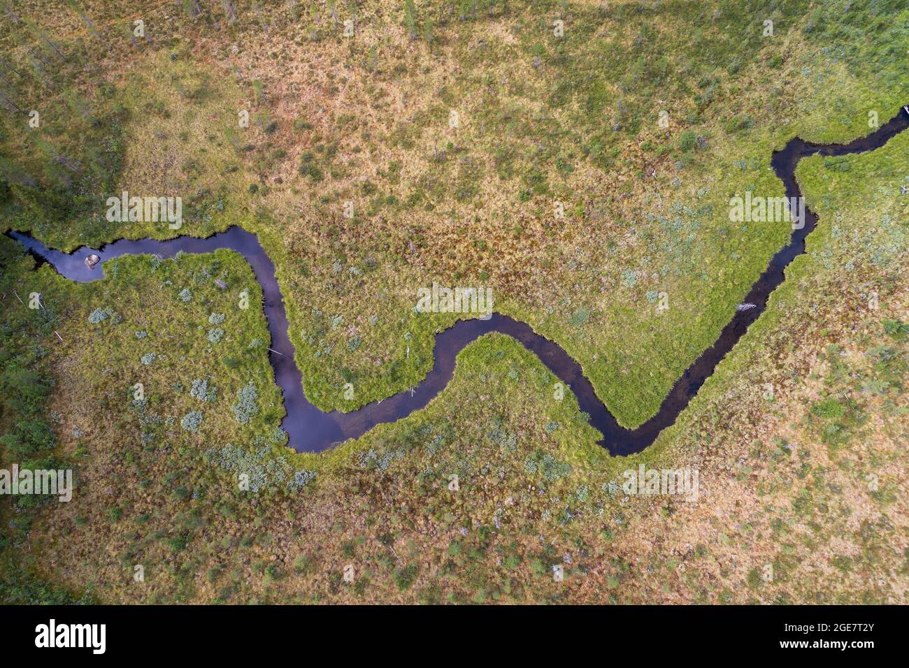 Aerial view of windling river in zig zag formation in desolate ...