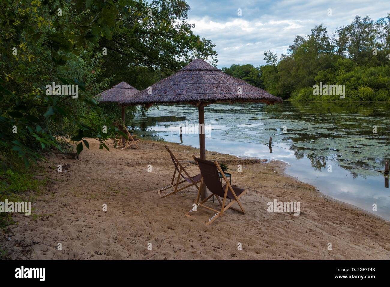 small beach with umbrellas Stock Photo - Alamy