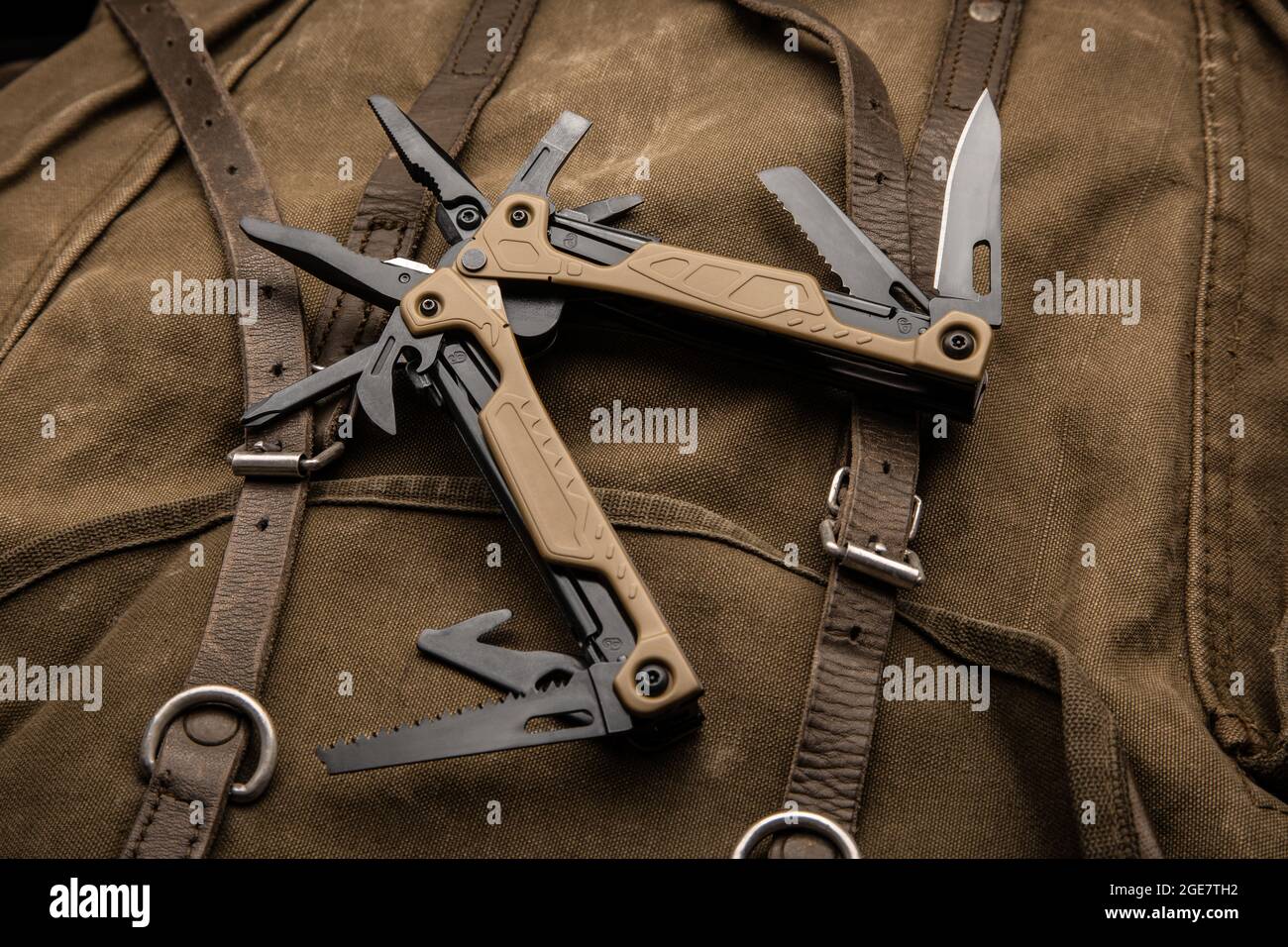 Modern multitool with many tools. A portable multitasking tool on a ...