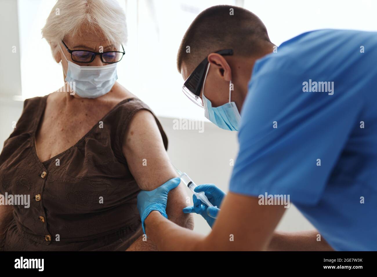 the doctor injects the vaccine to the patient hospital covid-19 Stock ...