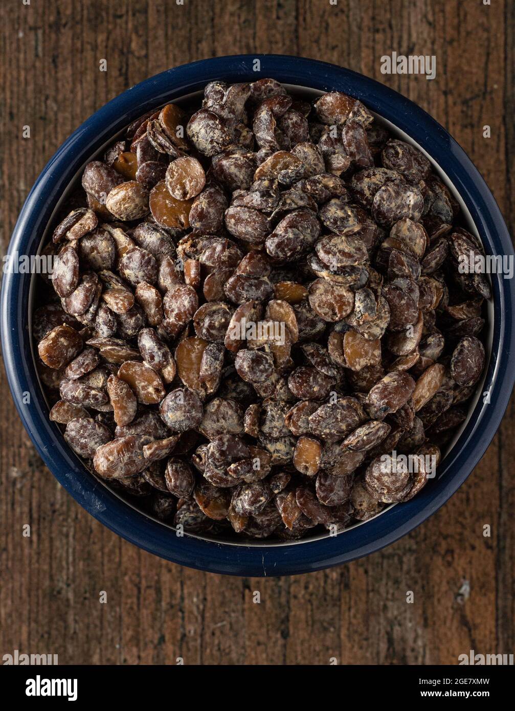 Fermented locust beans on a wooden background Stock Photo - Alamy