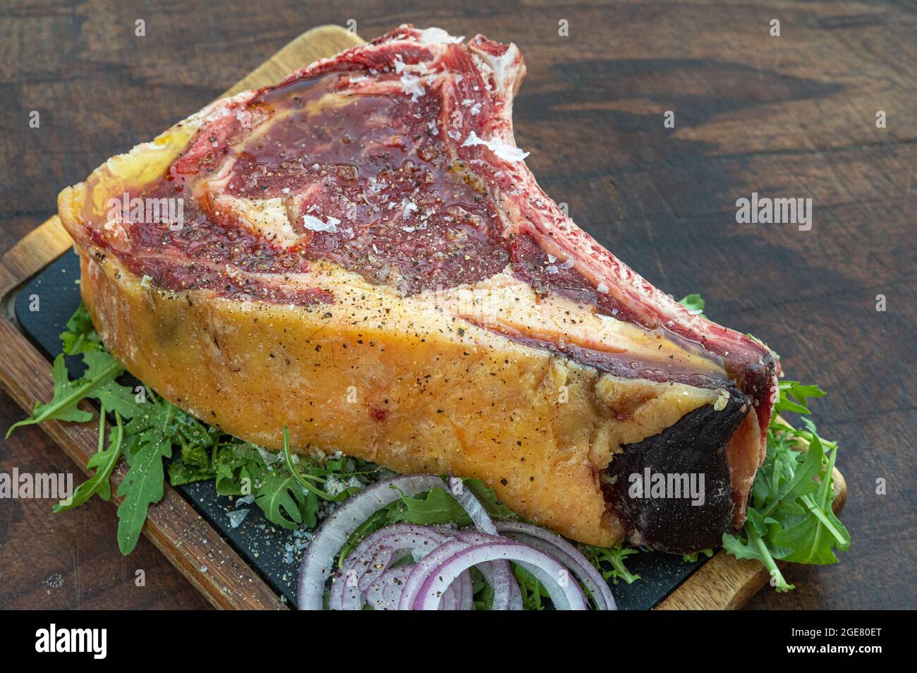 Delicious aged raw black angus beef steak ready-to-be-cooked on a ...