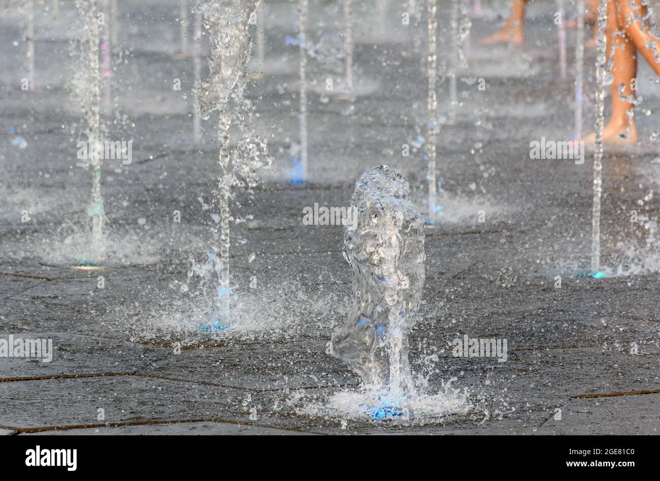 Close-up of water streams from flat fountain in pavement in city Stock ...