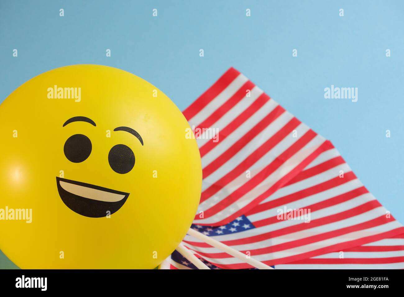Yellow emoji balloons with American flags on a blue background Stock ...