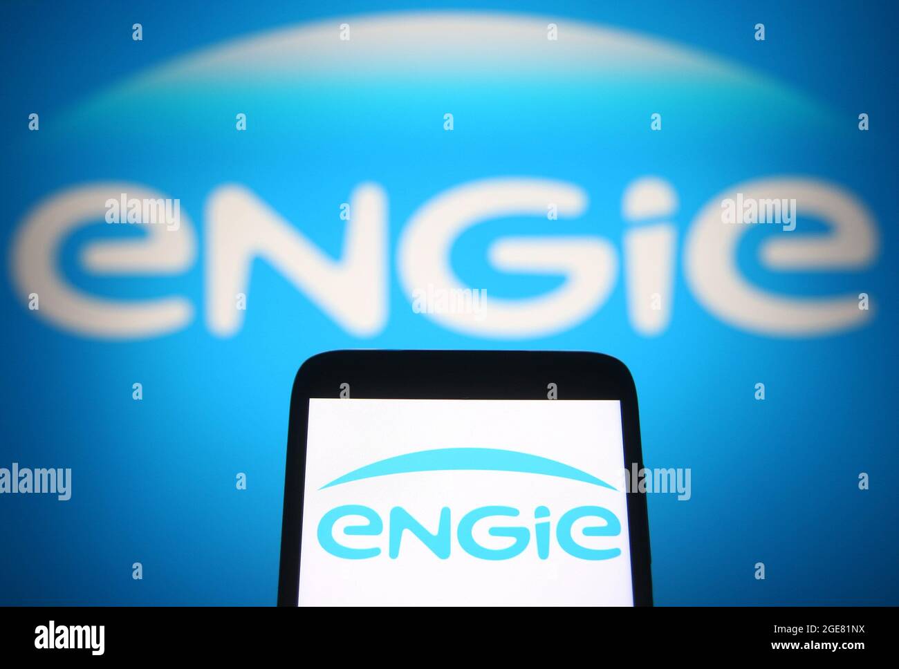 In this photo illustration, Engie logo is seen on a smartphone and a pc ...