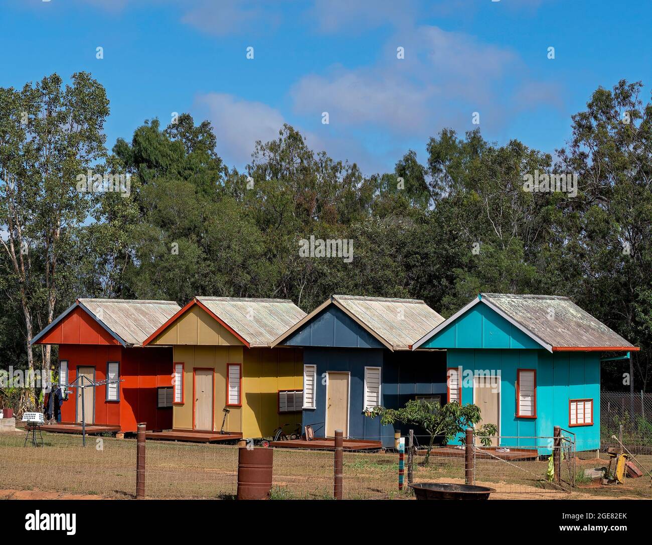 A row of colorful tiny houses in a rural area, each with their own ...