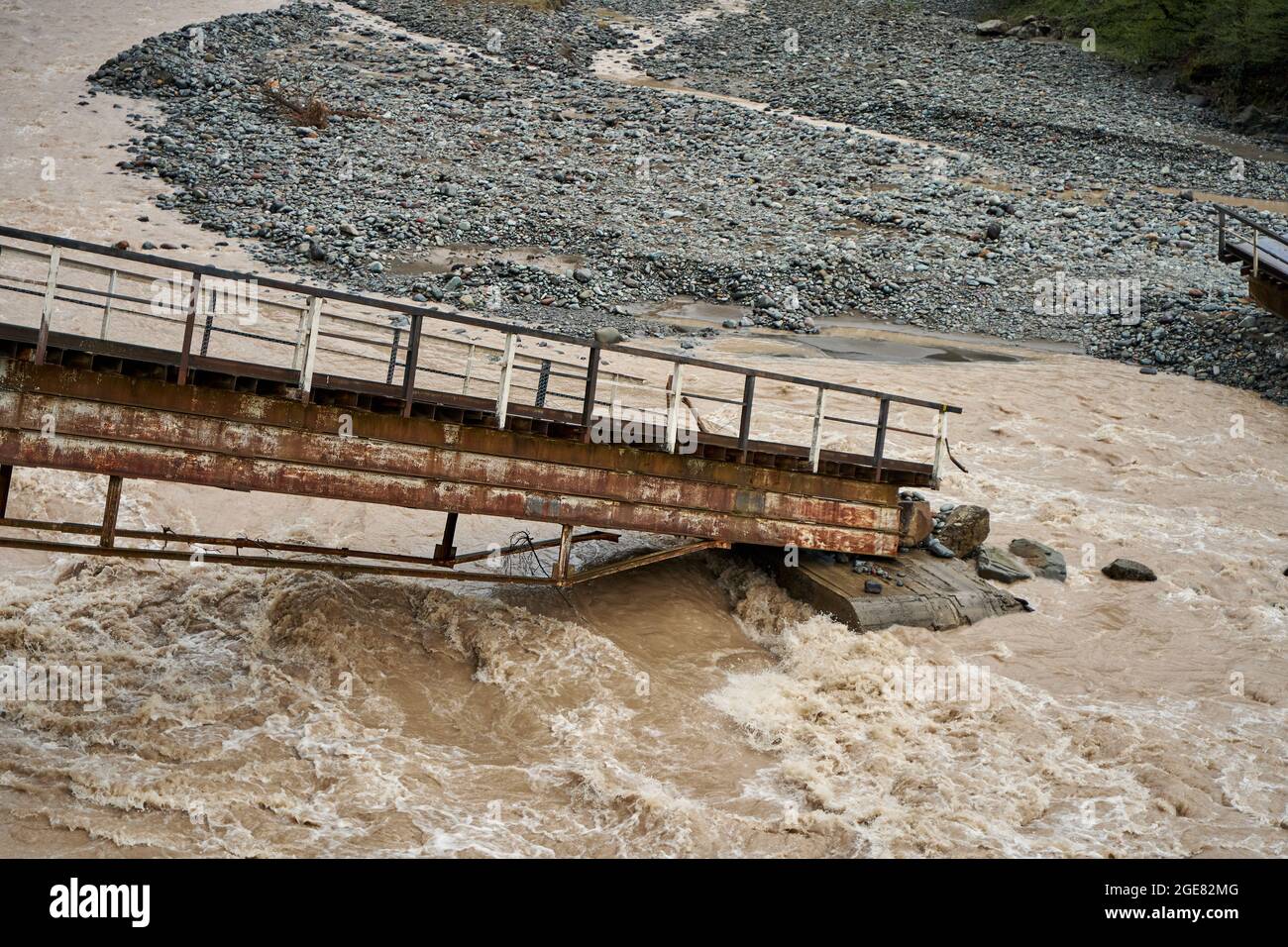 A bridge over a mountain river destroyed by water Stock Photo - Alamy