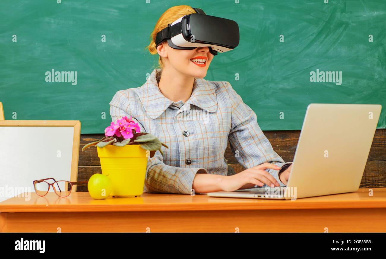 Happy tutor in classroom. Smiling Teacher with laptop in vr headset ...