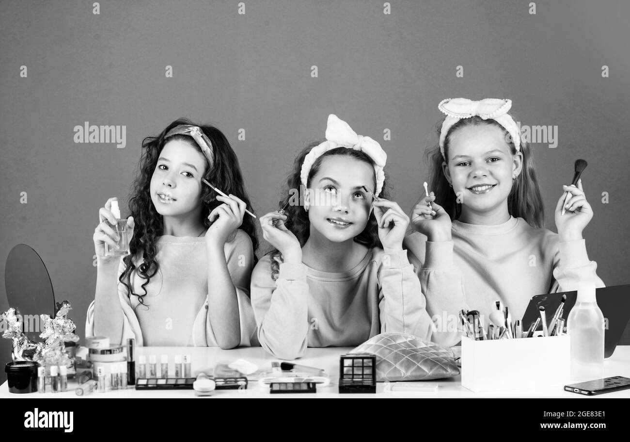 Hobby and fun. Happy girls doing makeup. Cute sisters play with ...