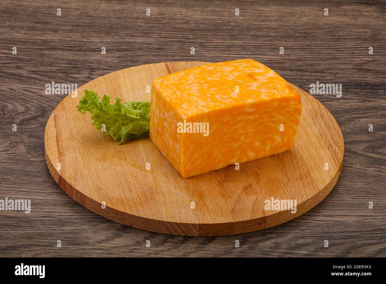 Dairy Marble cheese brick over board Stock Photo - Alamy