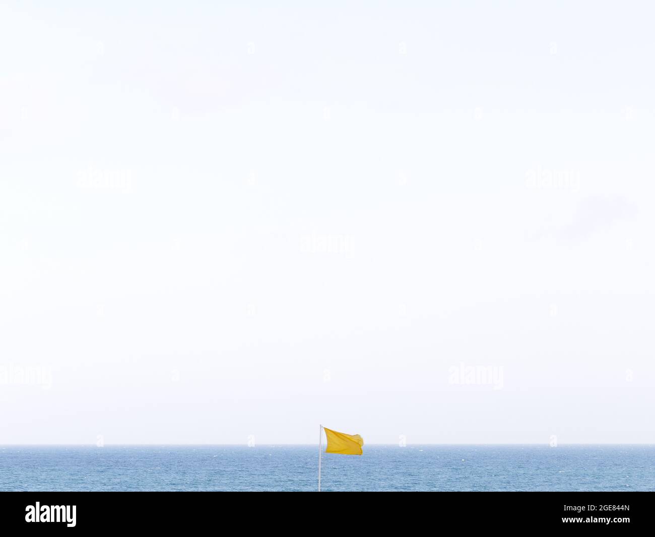 Minimalist photo of a yellow flag with the sea in the background Stock ...