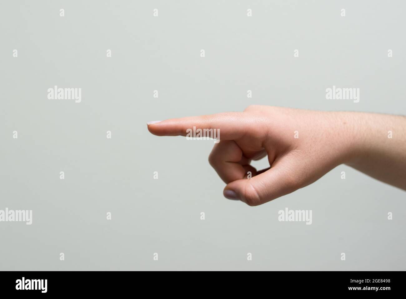 Closeup of a hand finger pointing on a white background Stock Photo - Alamy
