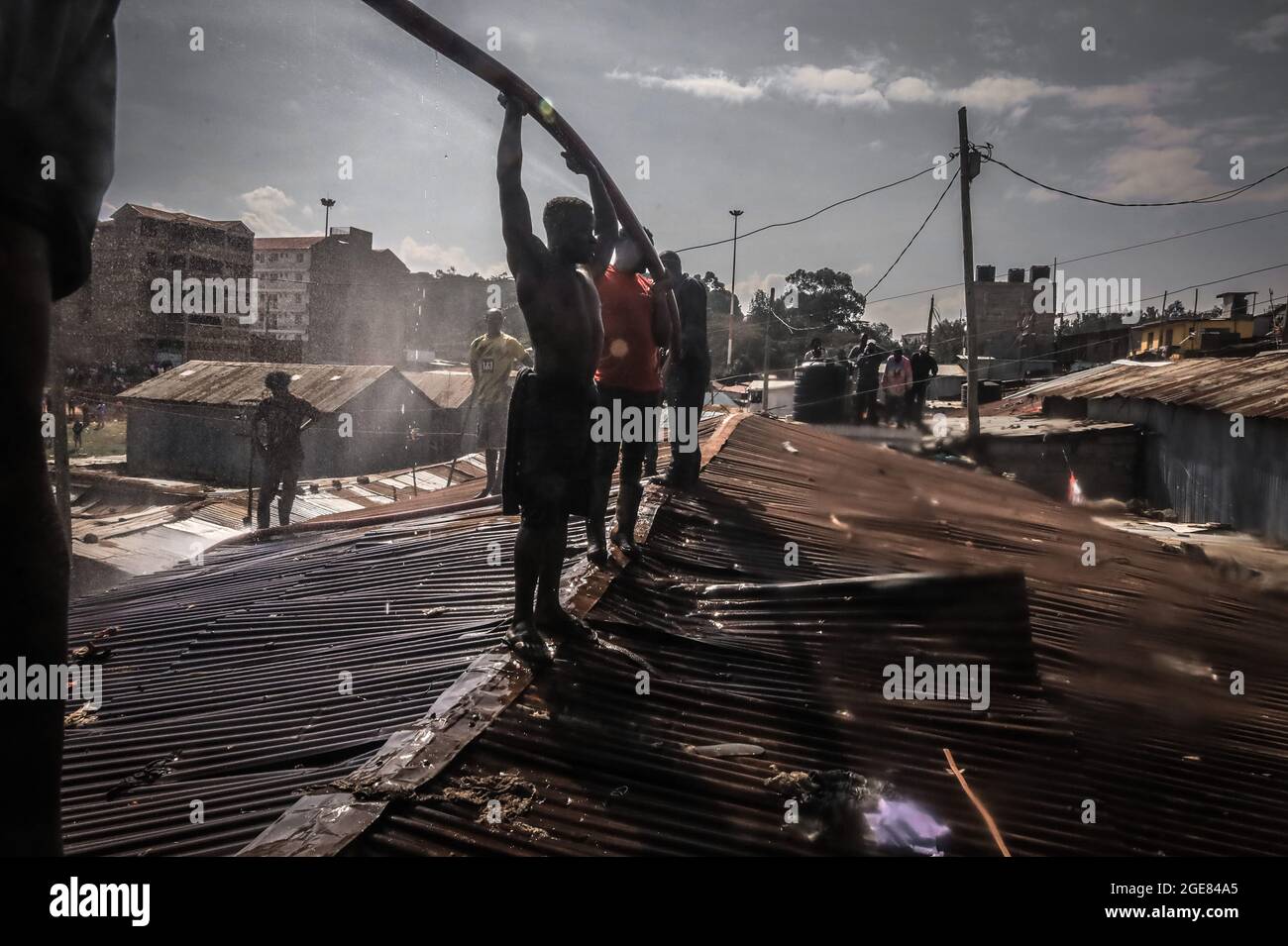 Nairobi, Kenya. 17th Aug, 2021. Residents are seen on the rooftop ...